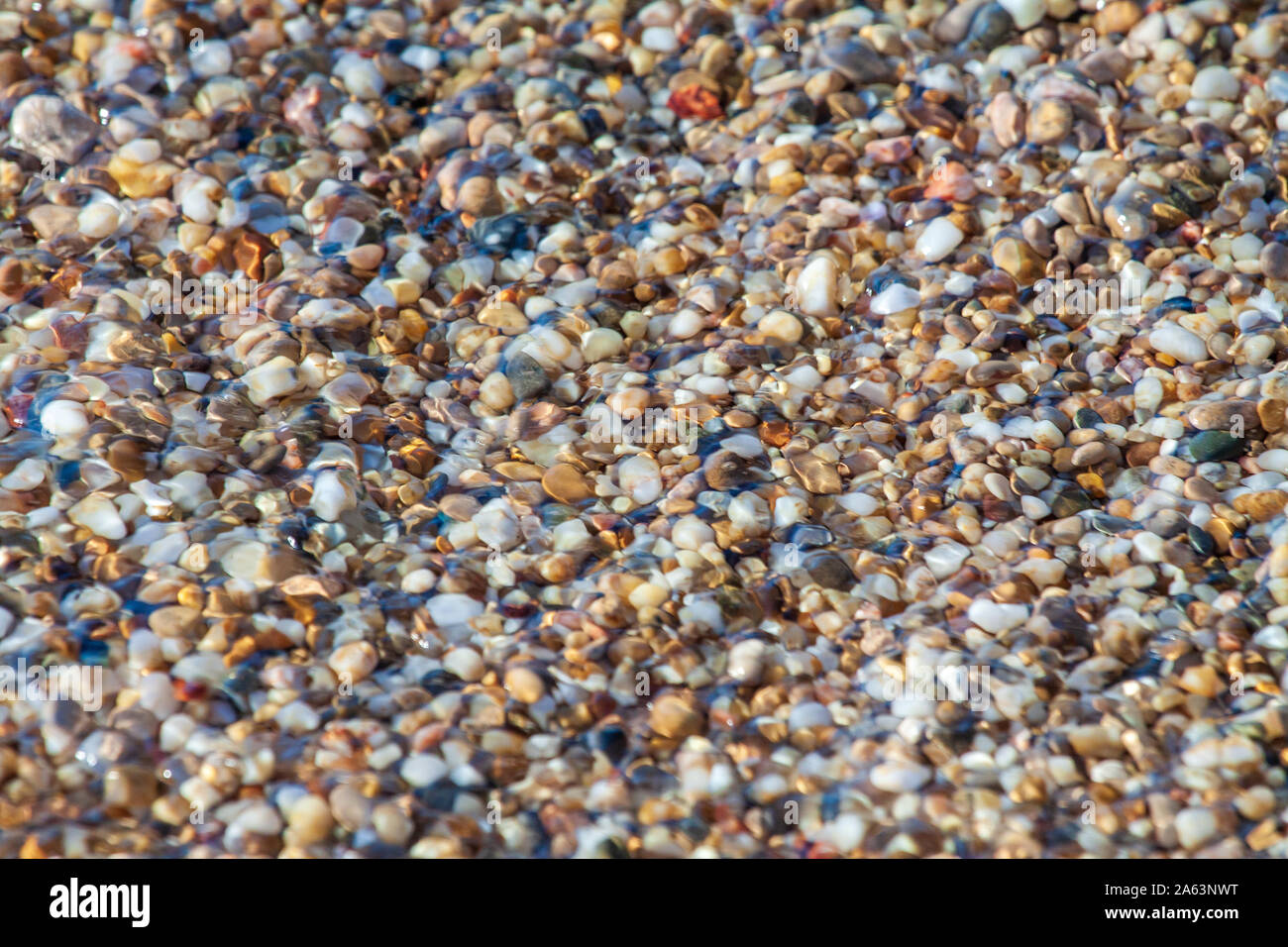 sea pebbles colored granite on the beach background stones. The shore ...