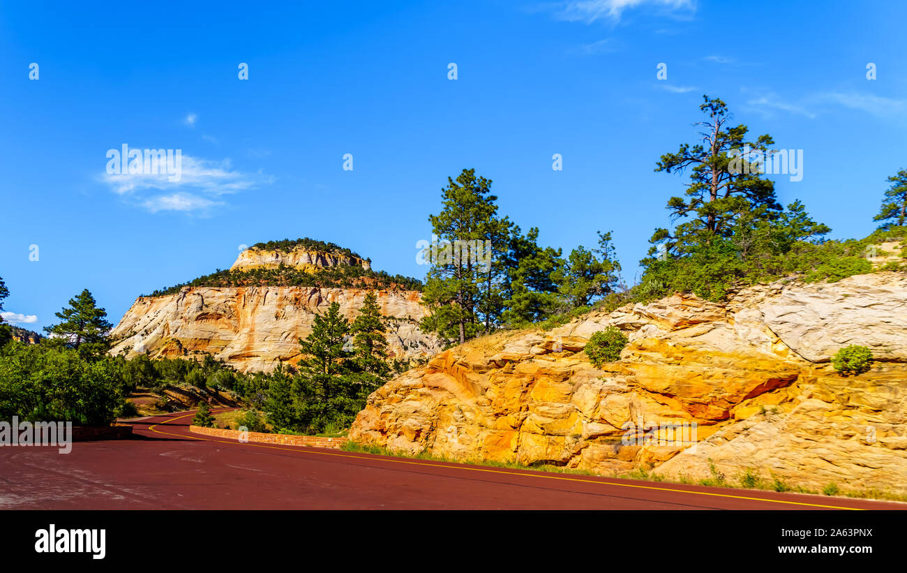 Red colored pavement of Zion-Mt.Carmel Highway as it winds through the ...