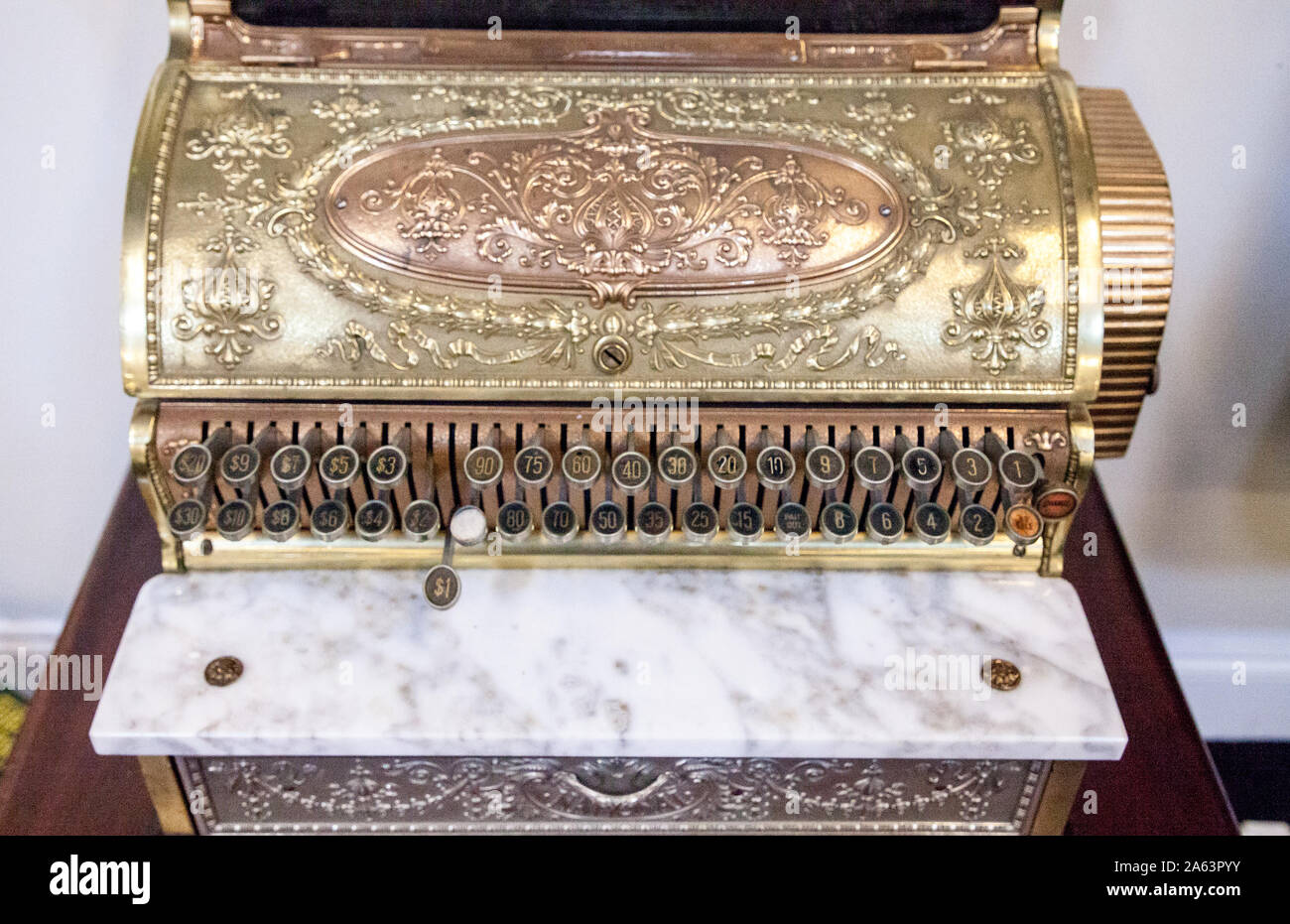 Gold and marble colored antique cash register with large gold keys and ...