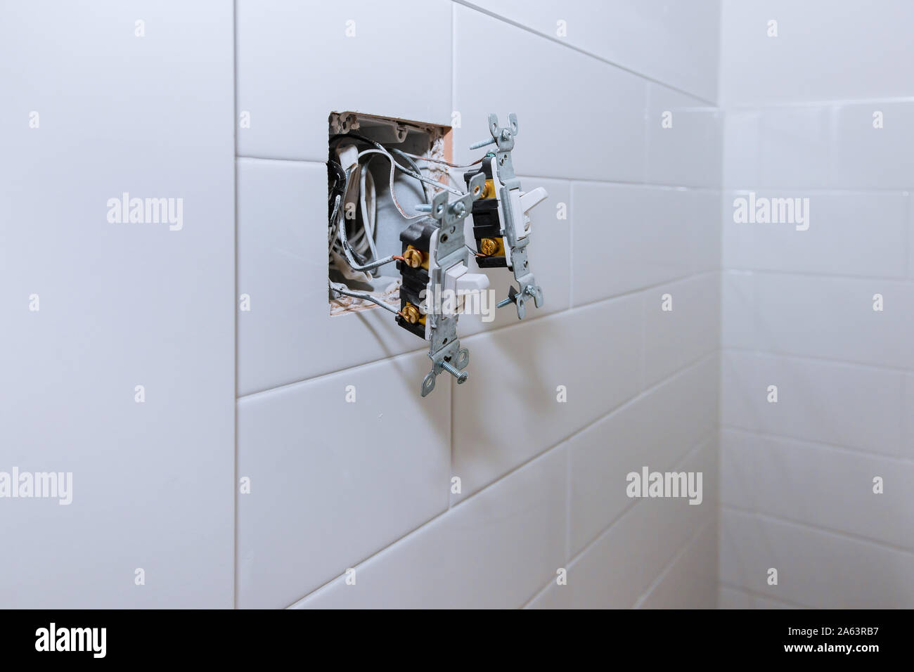 Installation process of electrical switch sockets in the bathroom Stock ...