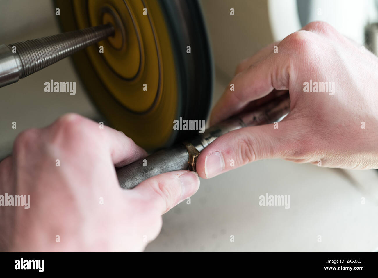 Jeweler Polishing A Gold Ring At Workbench - Goldsmith Making A Ring At ...