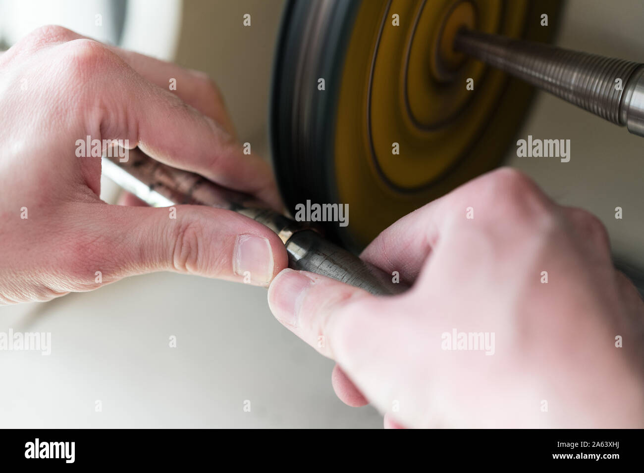 Jeweler Polishing A Gold Ring At Workbench - Goldsmith Making A Ring At ...
