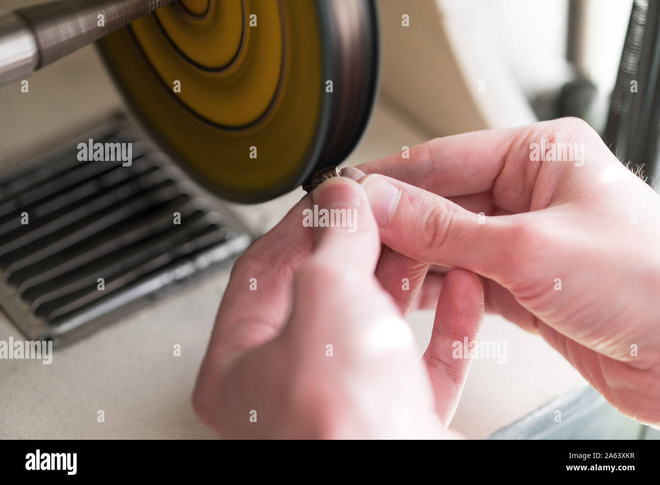 Jeweler Polishing A Gold Ring At Workbench - Goldsmith Making A Ring At ...
