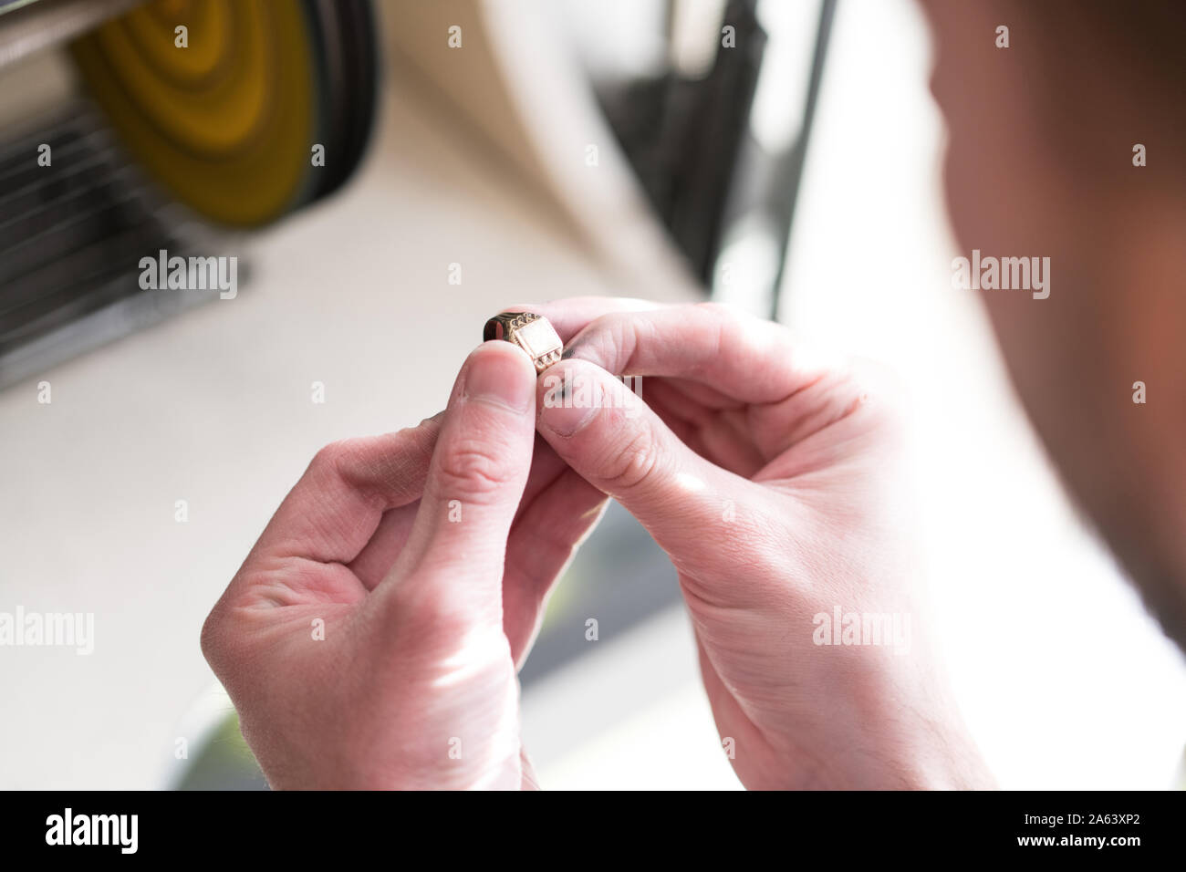 Jeweler Polishing A Gold Ring At Workbench - Goldsmith Making A Ring At ...