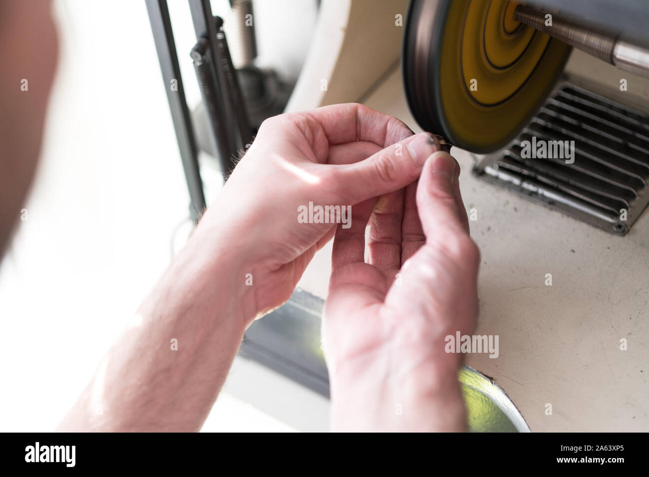 Jeweler Polishing A Gold Ring At Workbench - Goldsmith Making A Ring At ...