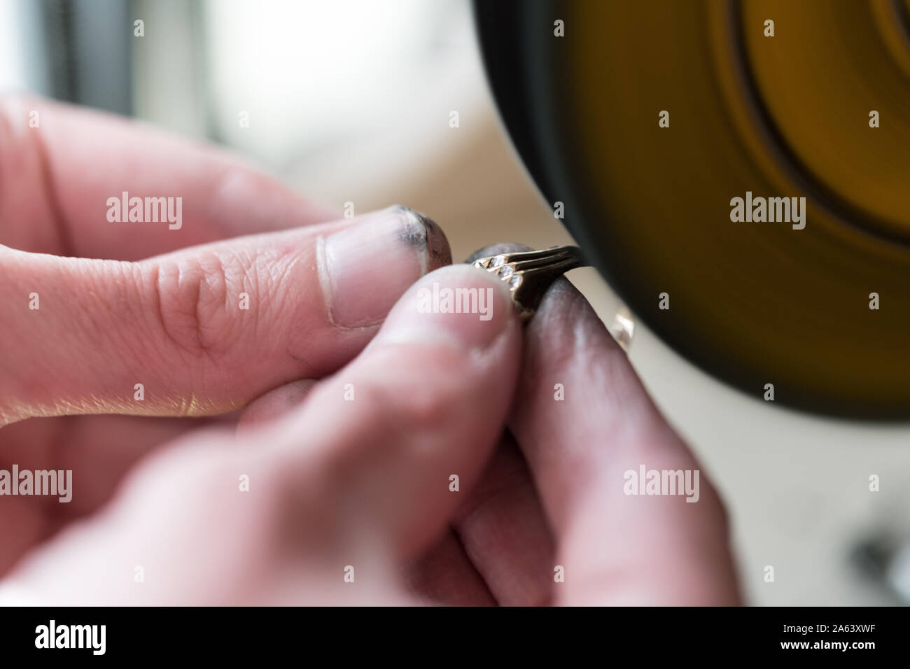 Jeweler Polishing A Gold Ring At Workbench - Goldsmith Making A Ring At ...