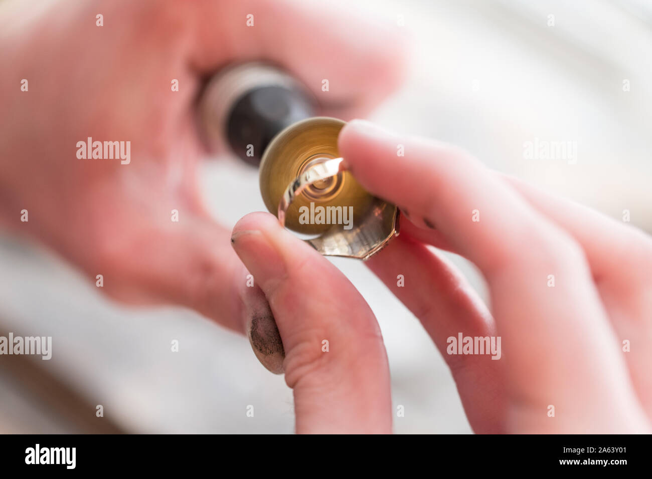 Jeweler Polishing A Gold Ring At Workbench - Goldsmith Making A Ring At ...
