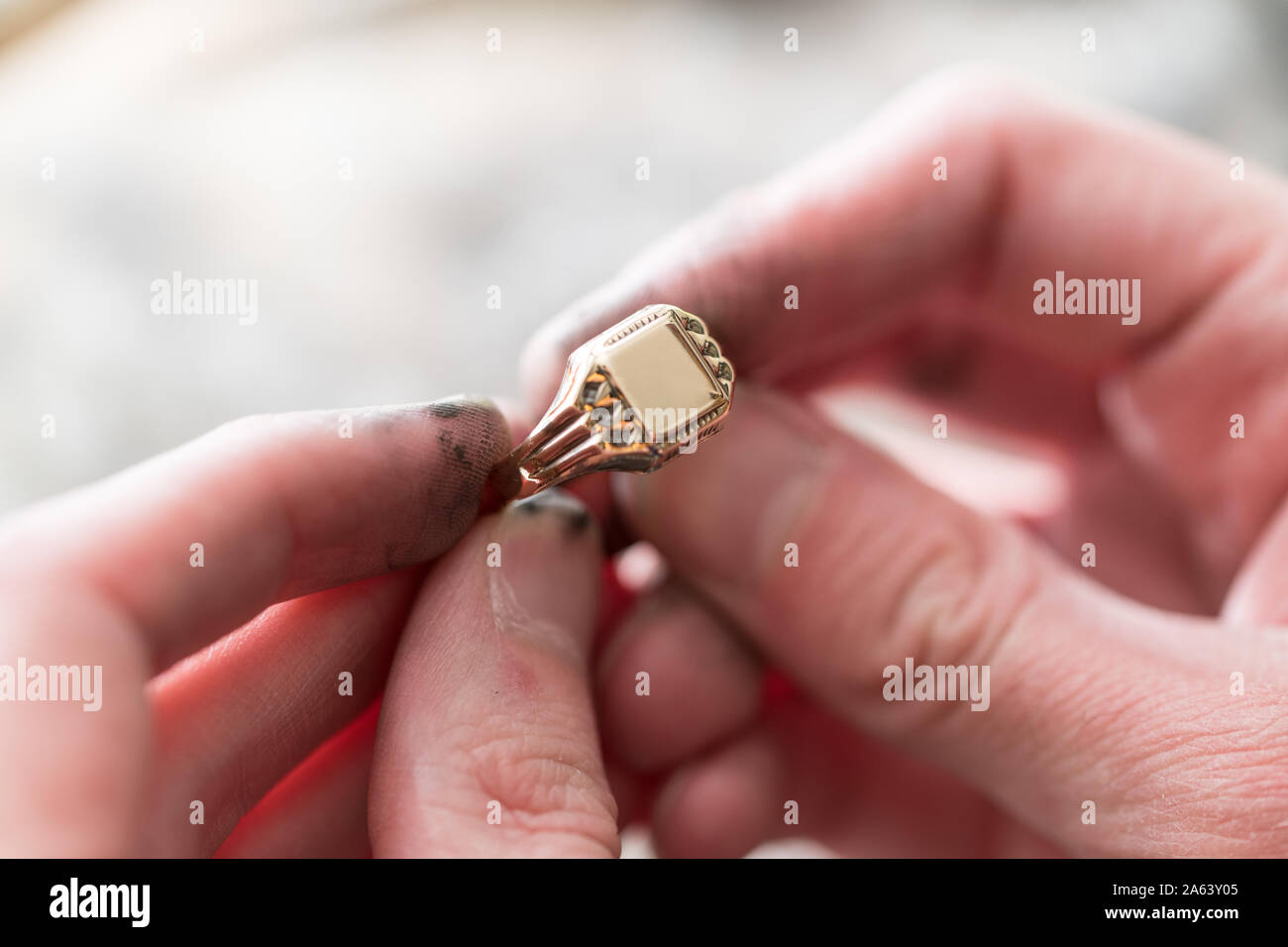 Jeweler Polishing A Gold Ring At Workbench - Goldsmith Making A Ring At ...