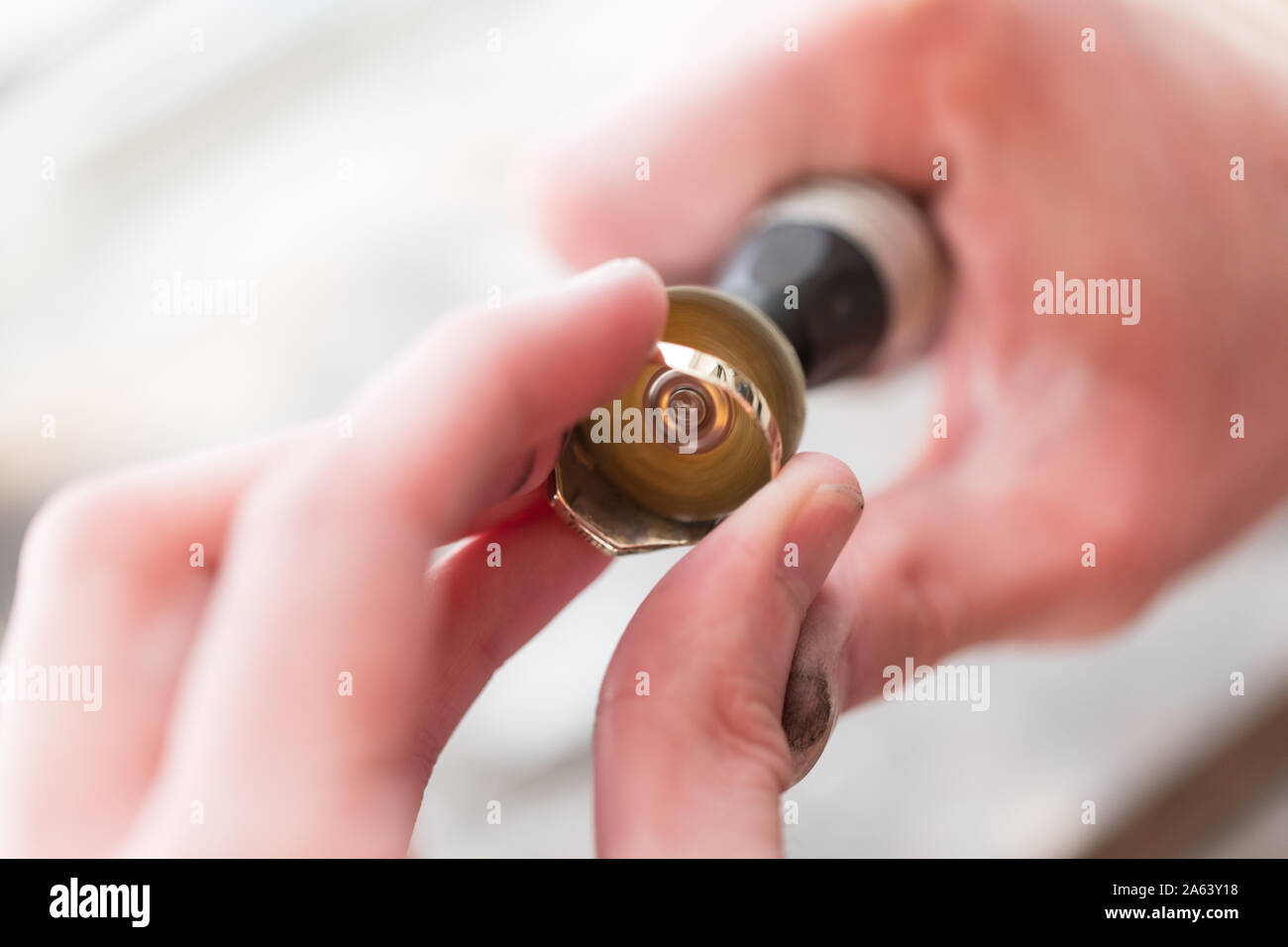 Jeweler Polishing A Gold Ring At Workbench - Goldsmith Making A Ring At ...