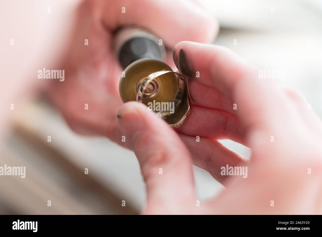 Jeweler Polishing A Gold Ring At Workbench - Goldsmith Making A Ring At ...