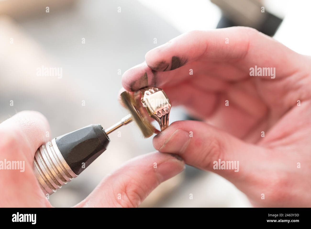 Jeweler Polishing A Gold Ring At Workbench - Goldsmith Making A Ring At ...