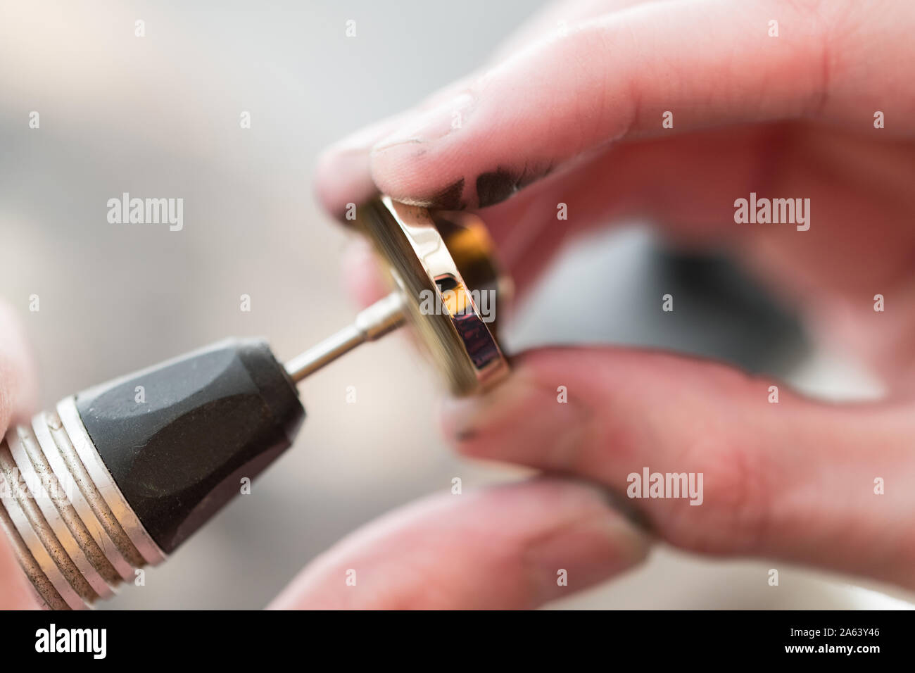 Jeweler Polishing A Gold Ring At Workbench - Goldsmith Making A Ring At ...