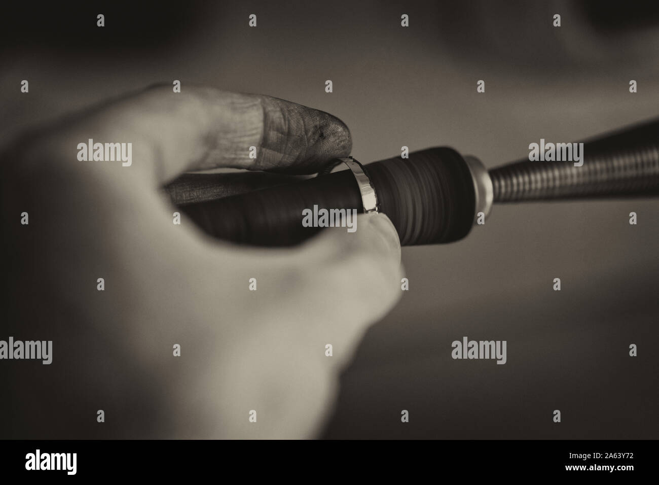 Jeweler Polishing A Gold Ring At Workbench - Goldsmith Making A Ring At ...