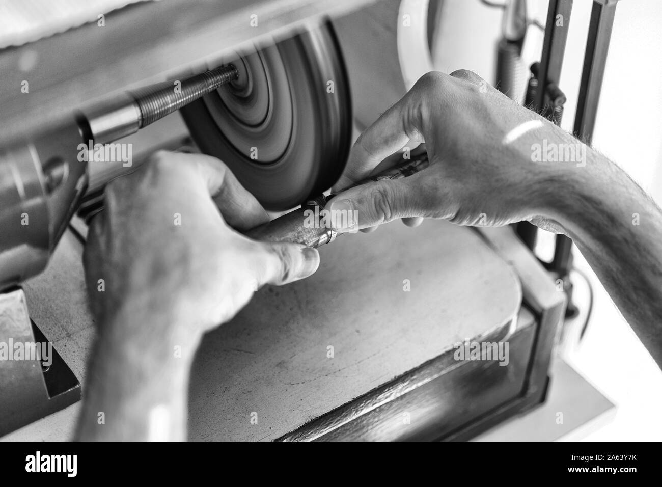 Jeweler Polishing A Gold Ring At Workbench - Goldsmith Making A Ring At ...