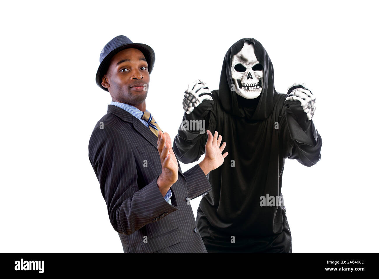 Man in a grim reaper halloween ghost costume having fun and scaring a ...
