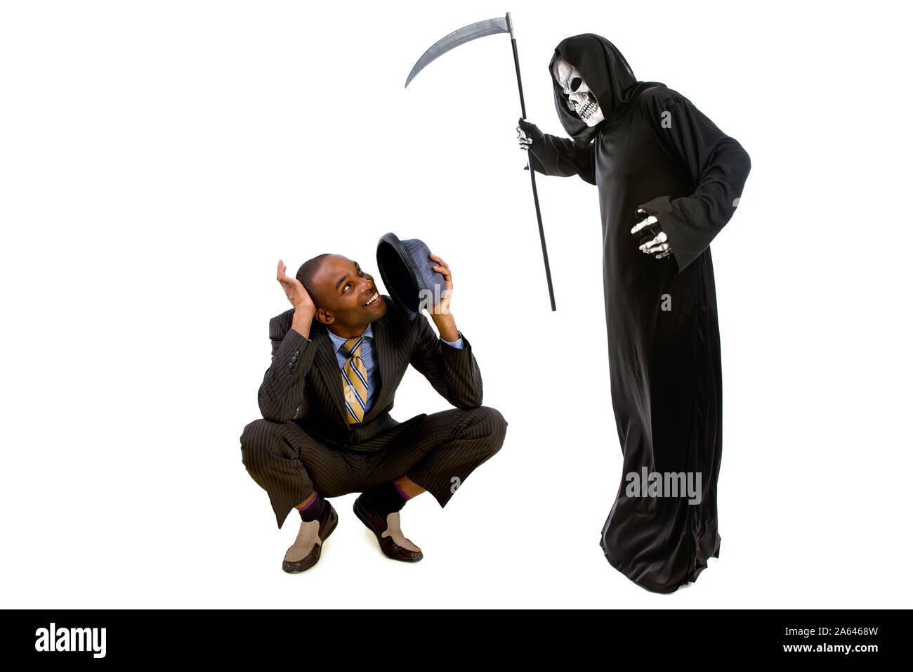 Man in a grim reaper halloween ghost costume having fun and scaring a ...