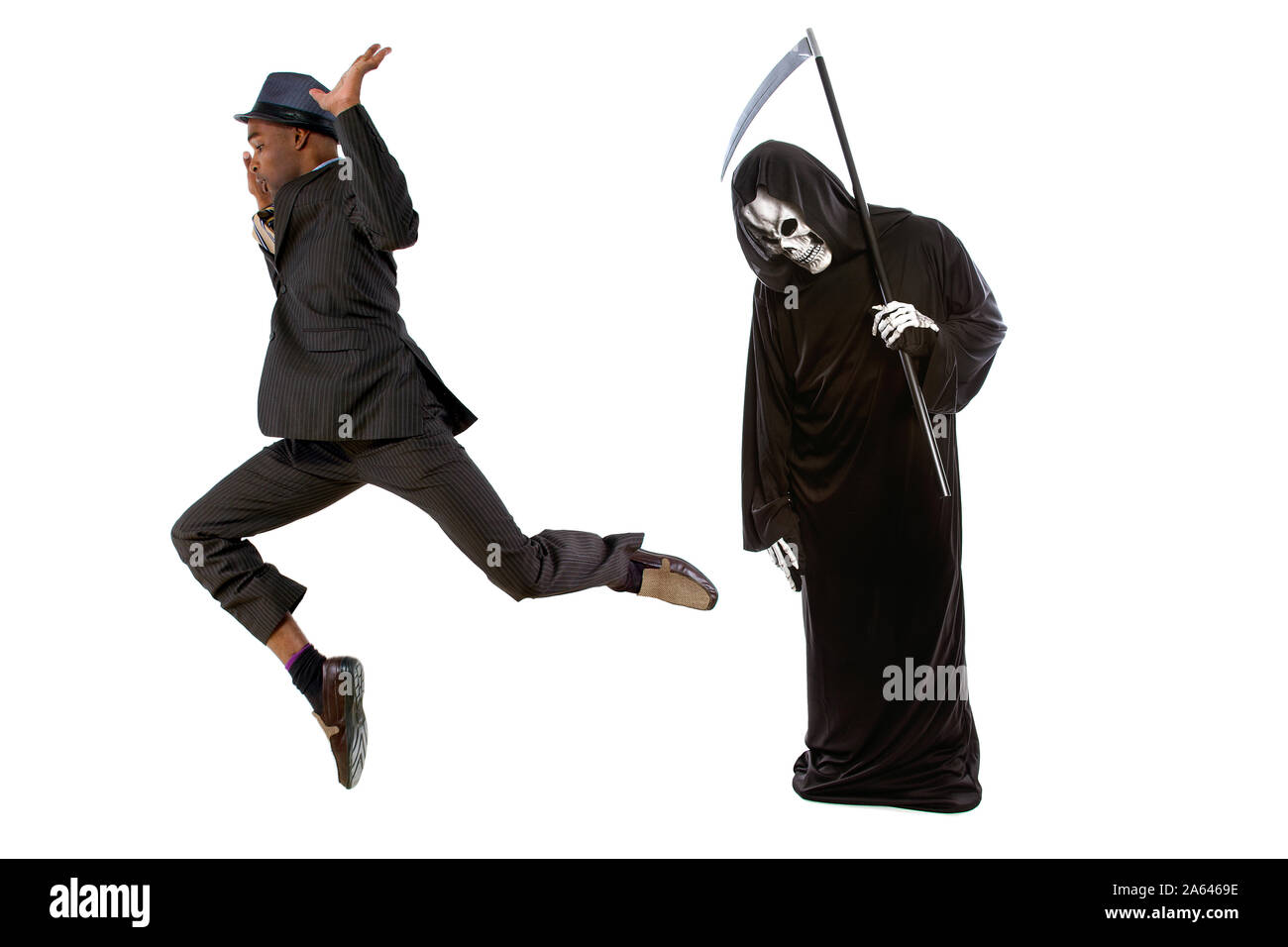 Man in a grim reaper halloween ghost costume having fun and scaring a ...