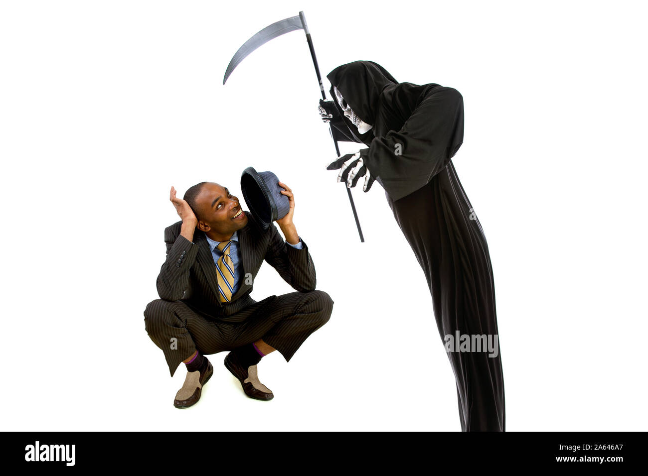 Man in a grim reaper halloween ghost costume having fun and scaring a ...