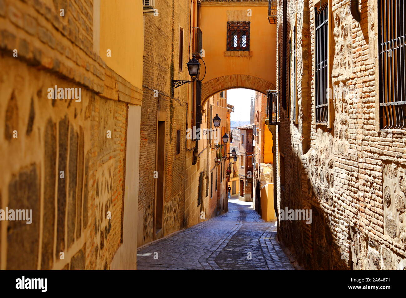 Traditional old Spanish street, in the historic city of Toledo, Spain ...