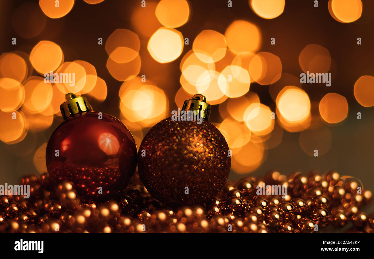 Two Christmas ornaments lying on balls of a Christmas chain on a ...