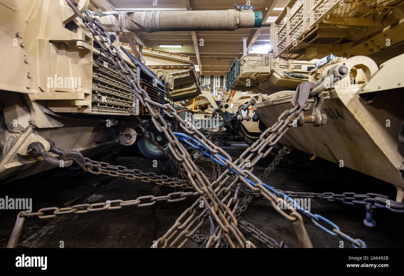 Army vehicles are shown fully secured on a Roll-on Roll-off Carrier (Ro ...