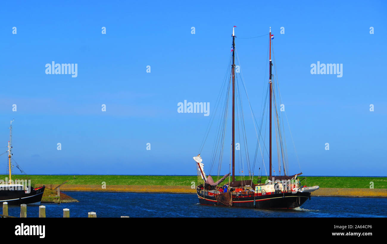 Stavoren, Holland - April 23, 2018: Sail boat leaving harbor on sunny ...