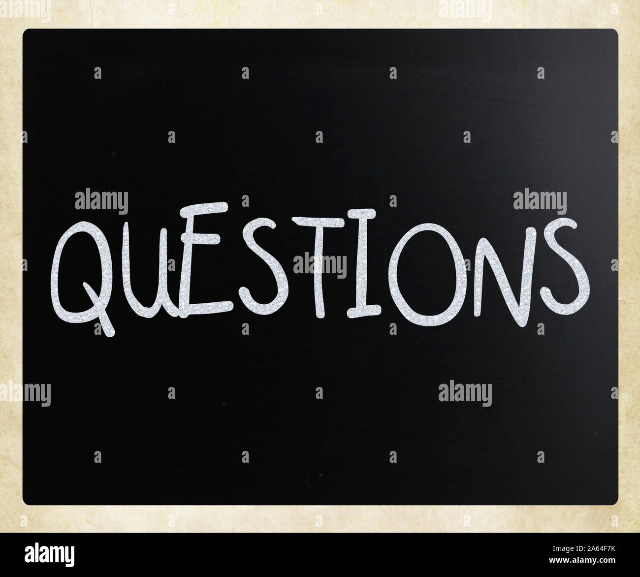 The word "Questions" handwritten with white chalk on a blackboard Stock ...
