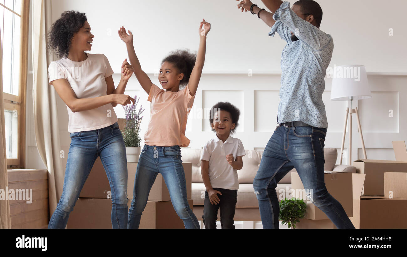 Smiling family with kids dance happy to move Stock Photo - Alamy