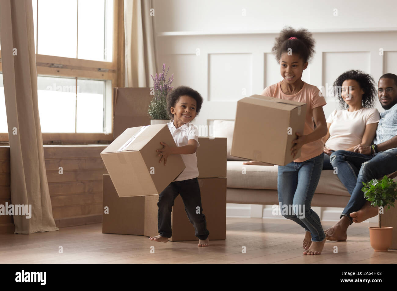 Playful small kids playing carrying boxes on moving day Stock Photo - Alamy