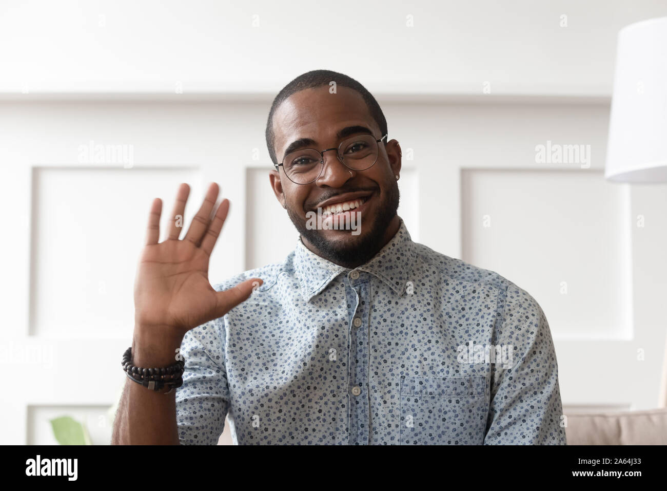 Smiling black man waving talking on video call Stock Photo - Alamy Smiling black man waving talking on video call Stock Photo - Alamy