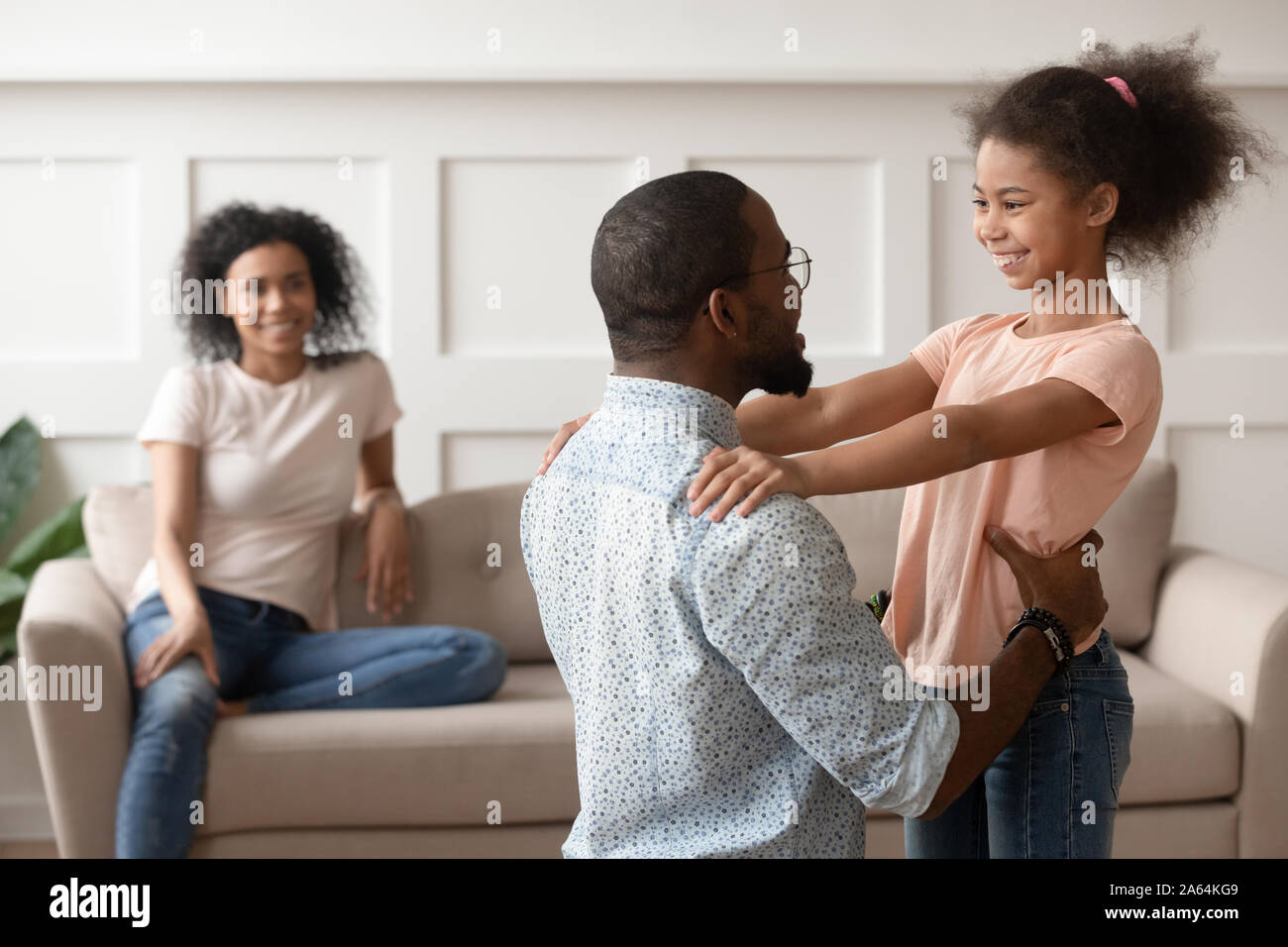 Happy black dad and daughter hug reunited after parting Stock Photo - Alamy