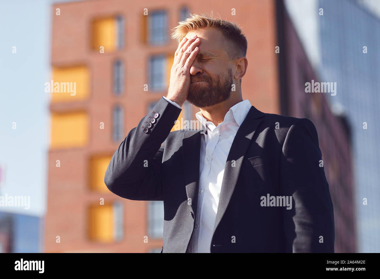 Crisis concept stress problem. Businessman covered his face with his ...