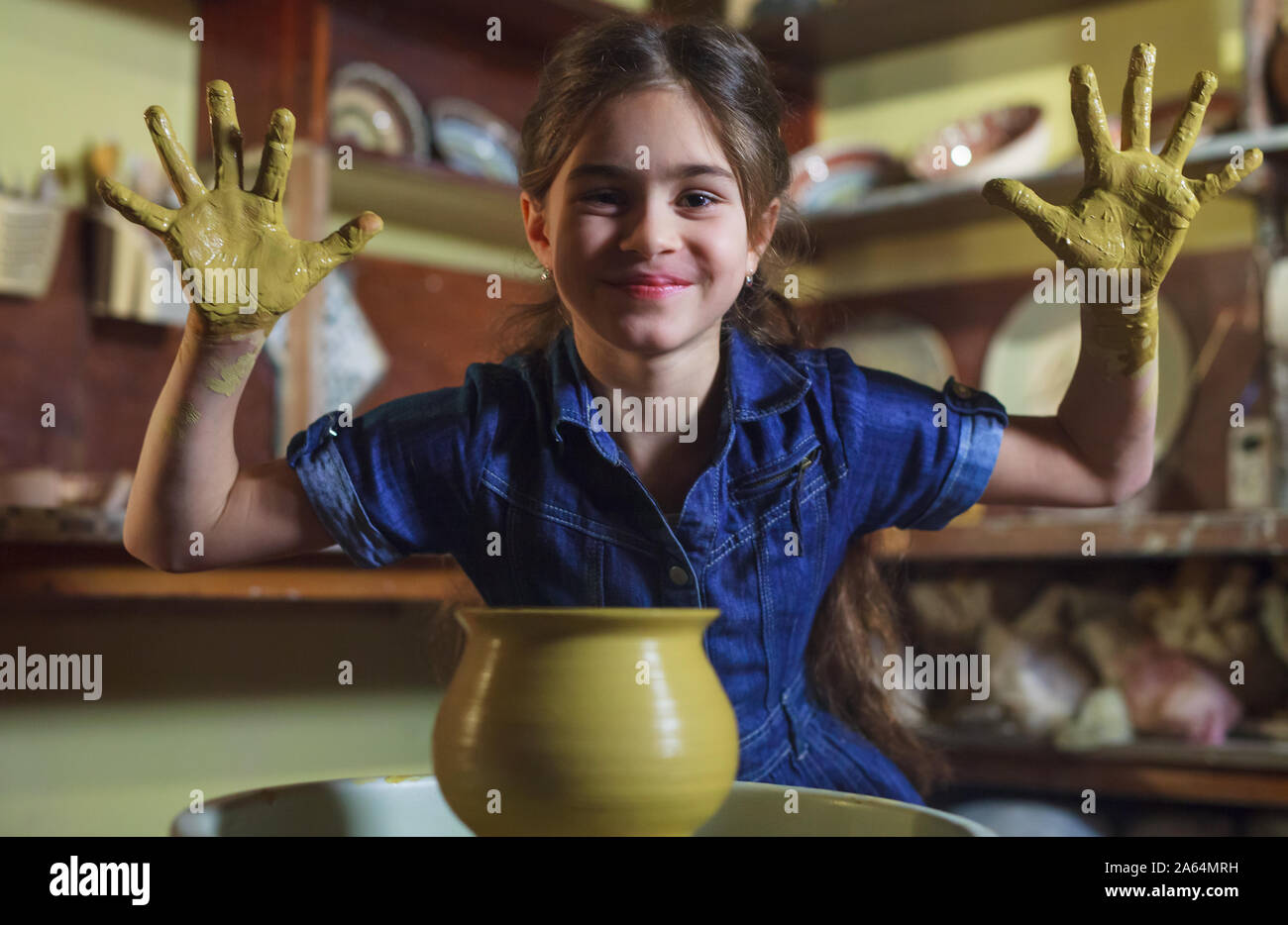 the master with the child molds a clay jug Stock Photo - Alamy
