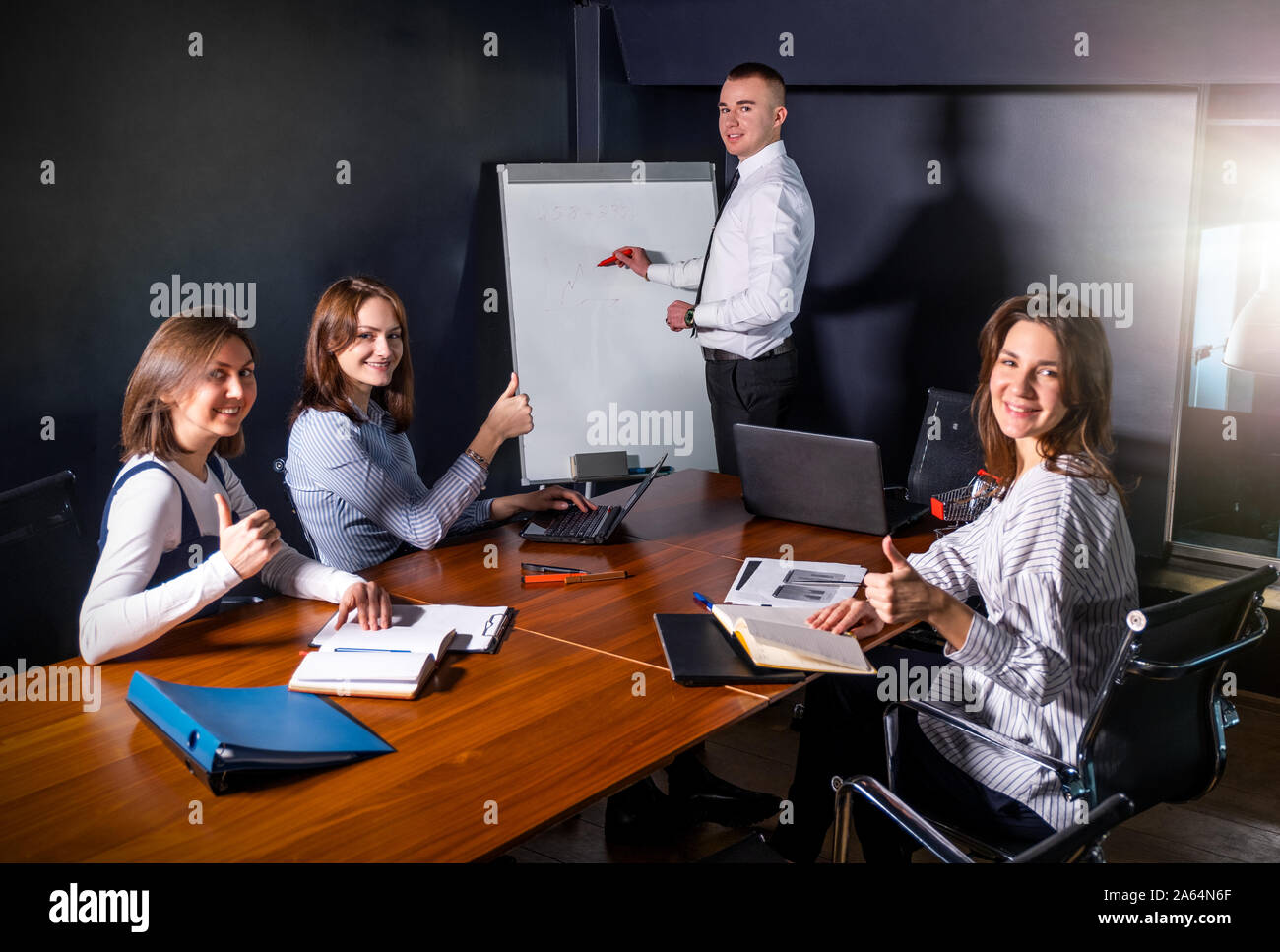 boss at meeting draws a marker graph on board Stock Photo - Alamy