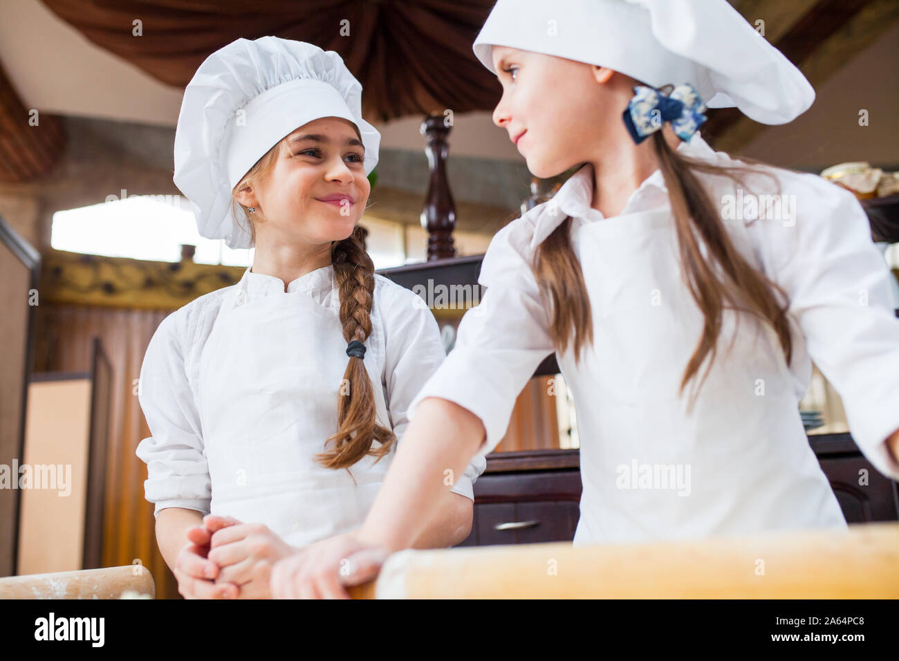 two girls make flour dough Stock Photo - Alamy