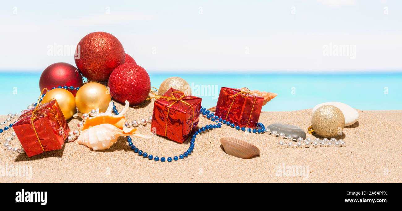 Christmas tree decorations on the beach in tropical sea. Concept of new ...