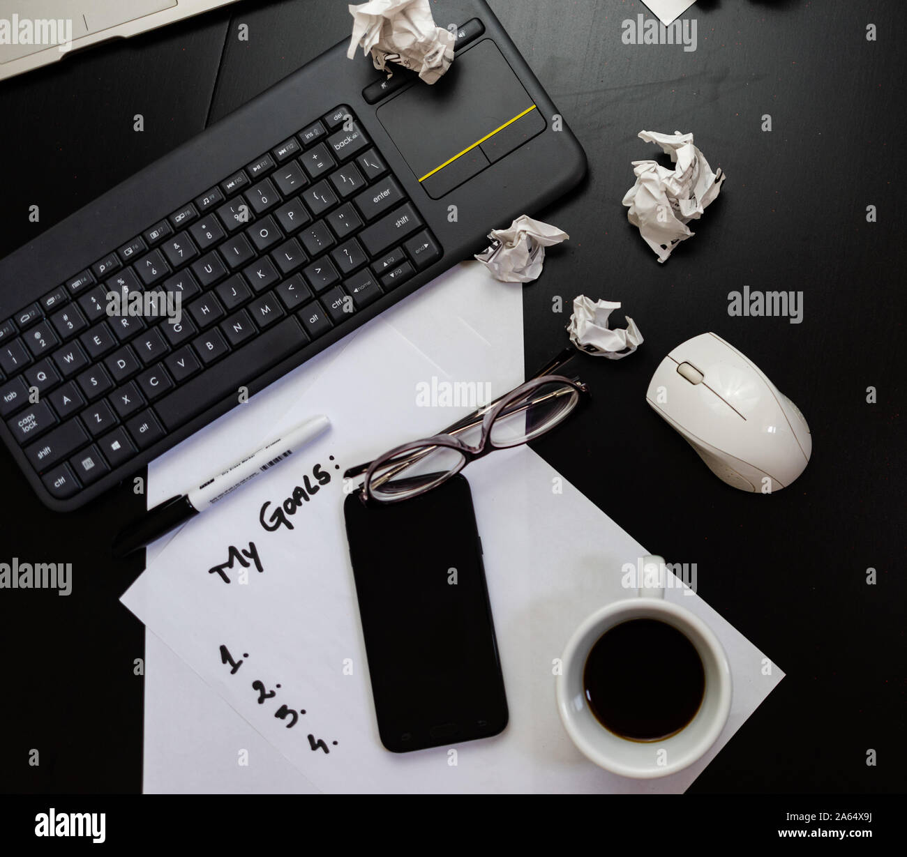 Different objects on black office desk. Modern black office desk table ...