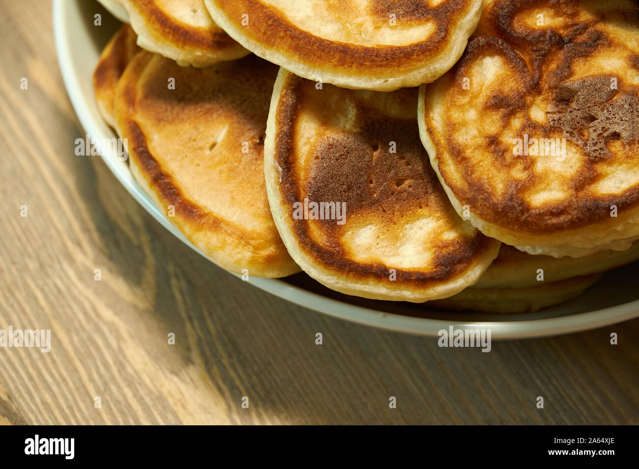 Stack of delicious homemade pancakes on plate, wooden table as ...