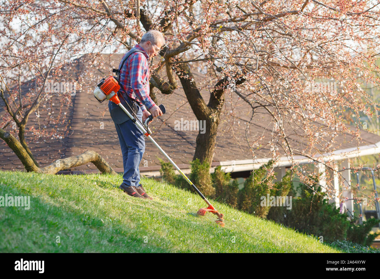 Worker mows green grass manual hi-res stock photography and images - Alamy