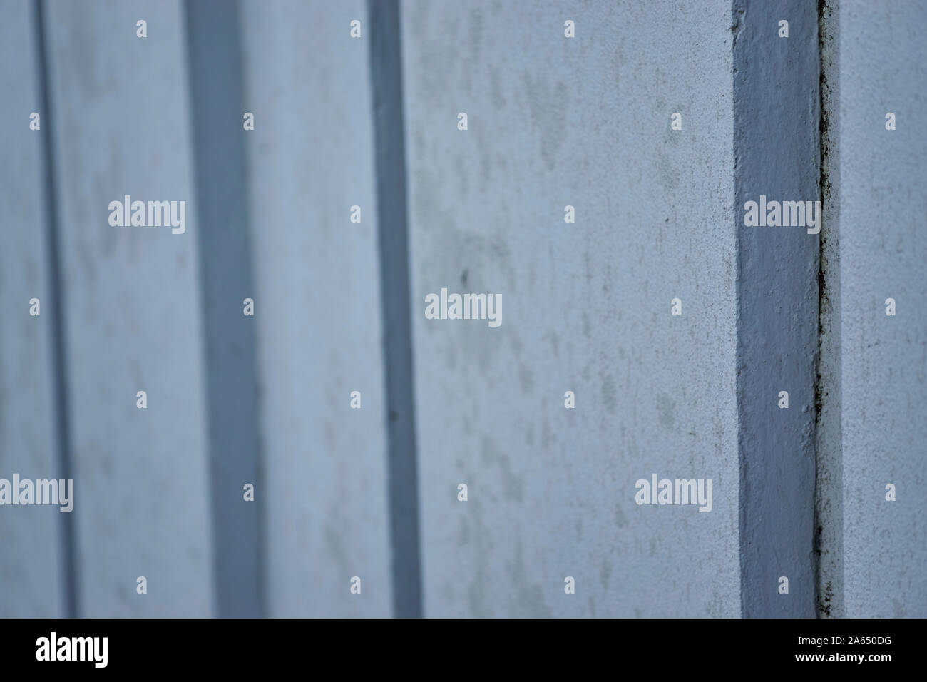 Background image made up of a close up of a modern ribbed concrete wall ...