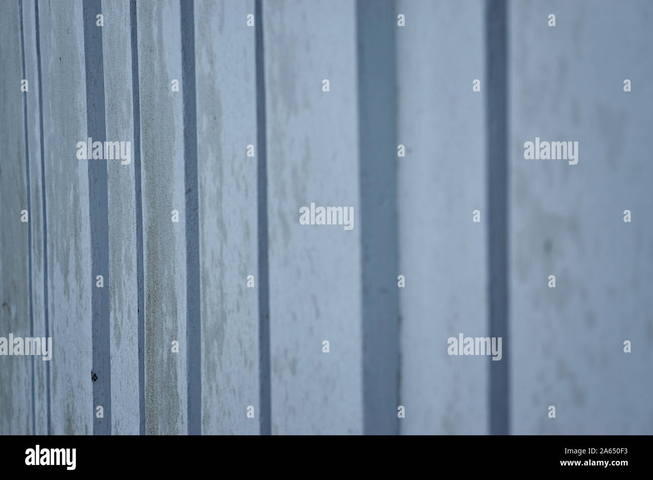 Background image made up of a close up of a modern ribbed concrete wall ...