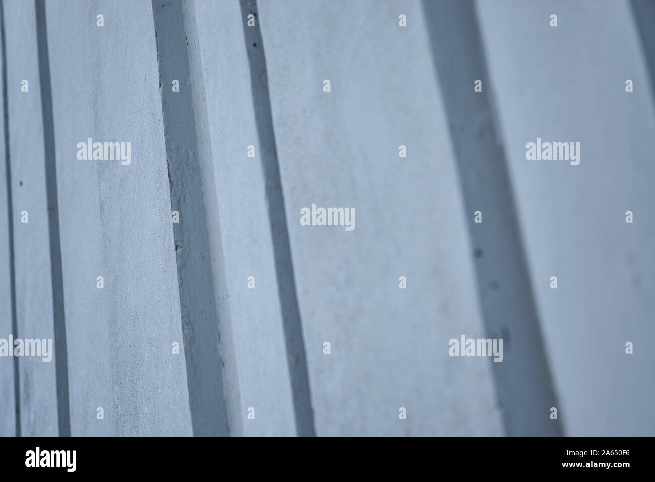 Background image made up of a close up of a modern ribbed concrete wall ...