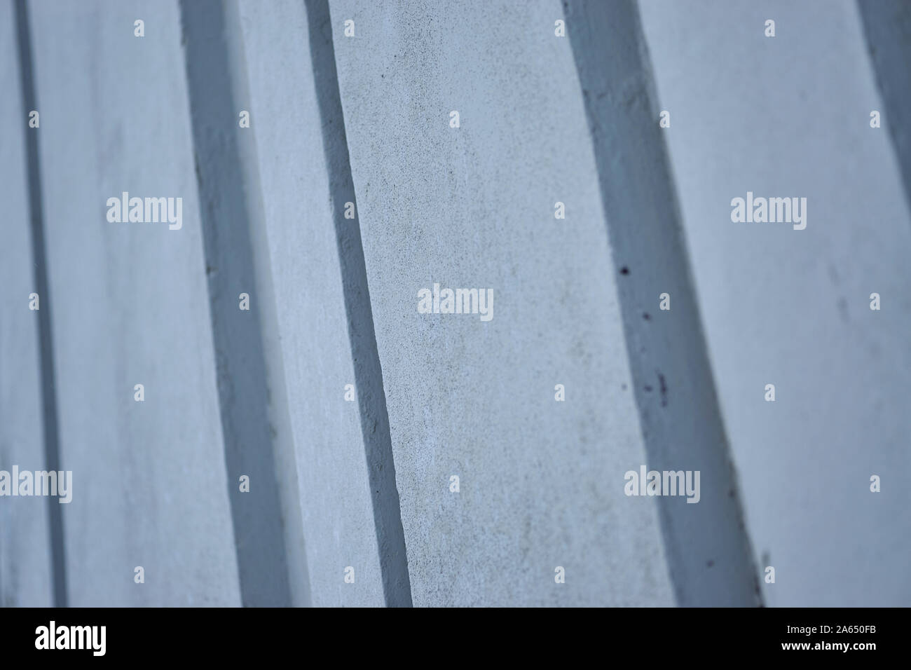 Background image made up of a close up of a modern ribbed concrete wall ...