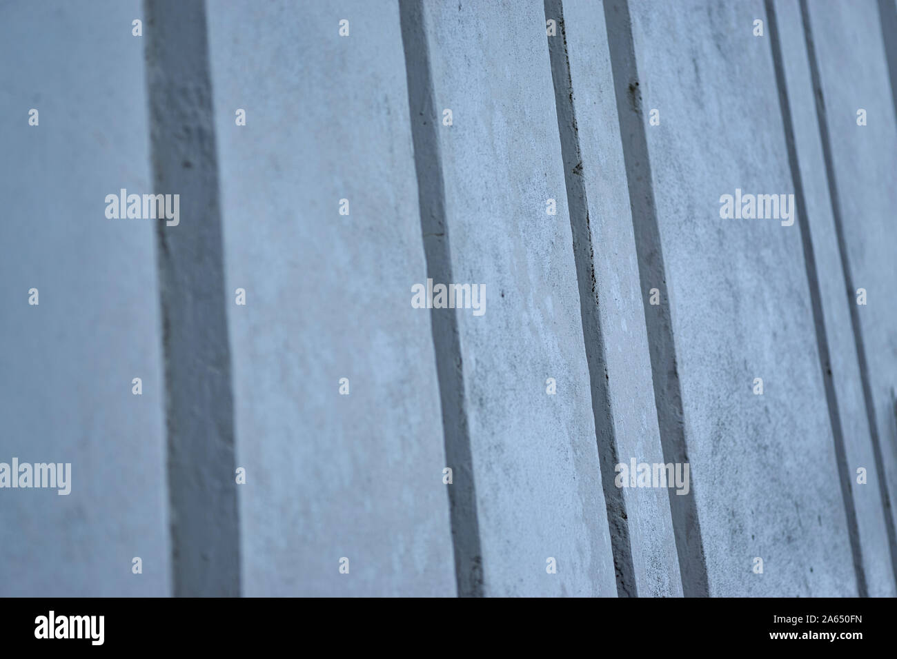 Background image made up of a close up of a modern ribbed concrete wall ...