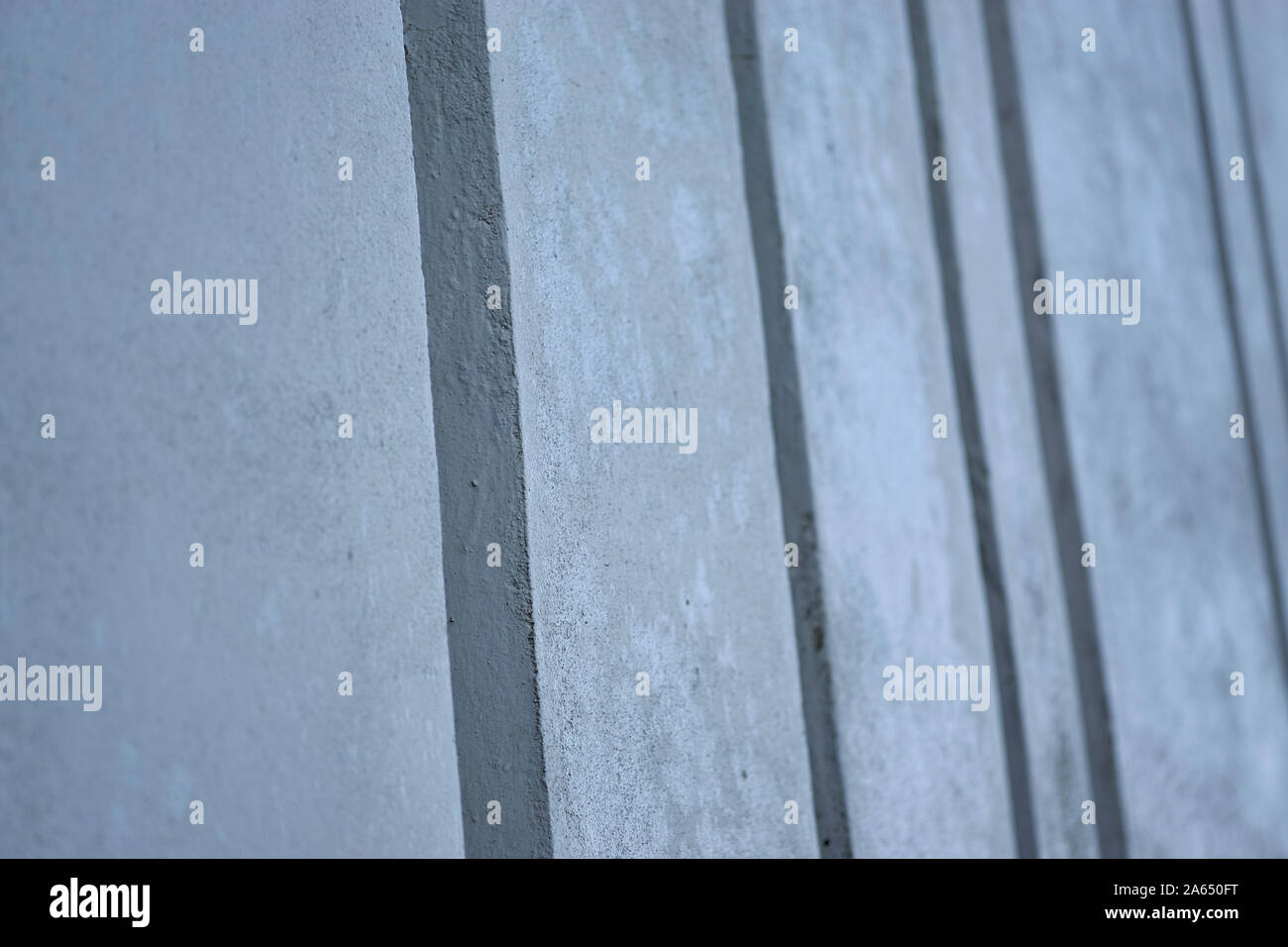 Background image made up of a close up of a modern ribbed concrete wall ...