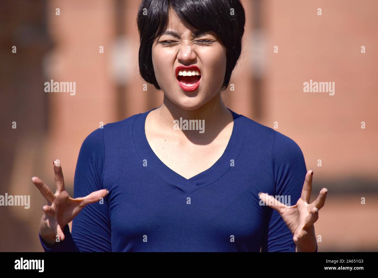 Woman And Anger Wearing A Wig Stock Photo - Alamy