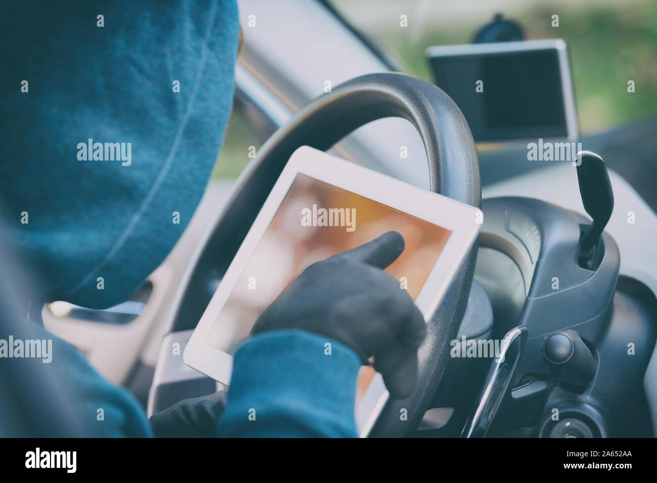 Hooded thief tries to break the car's security systems with tablet ...