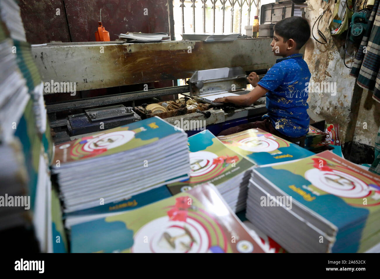 Dhaka, Bangladesh - October 22, 2019. Bangladeshi book binding worker ...