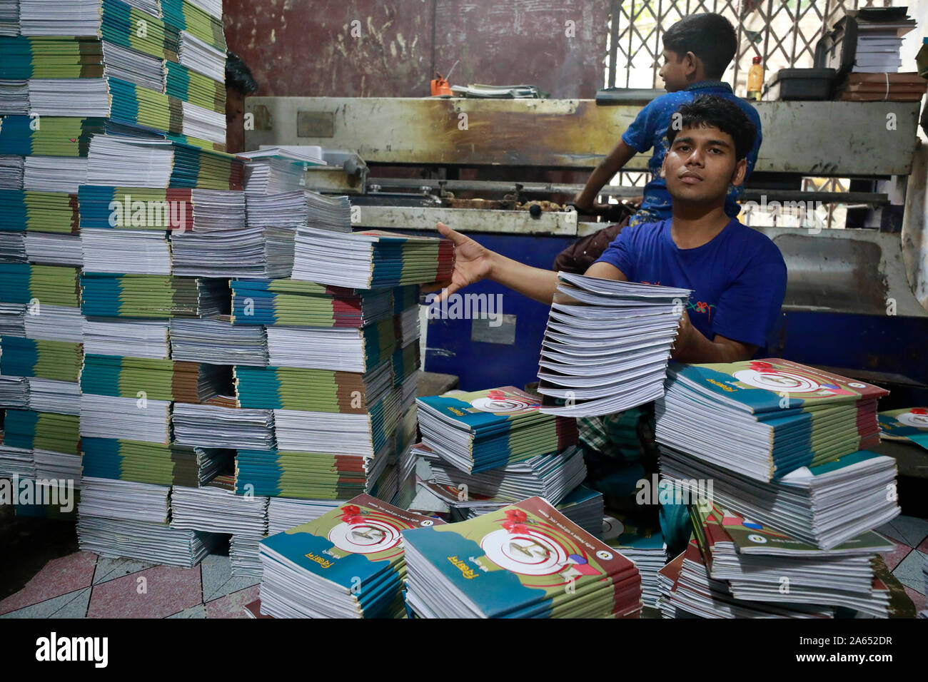 Dhaka, Bangladesh - October 22, 2019. Bangladeshi book binding worker ...