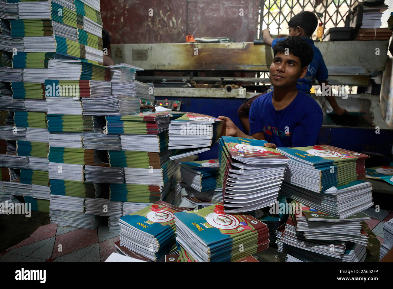Dhaka, Bangladesh - October 22, 2019. Bangladeshi book binding worker ...